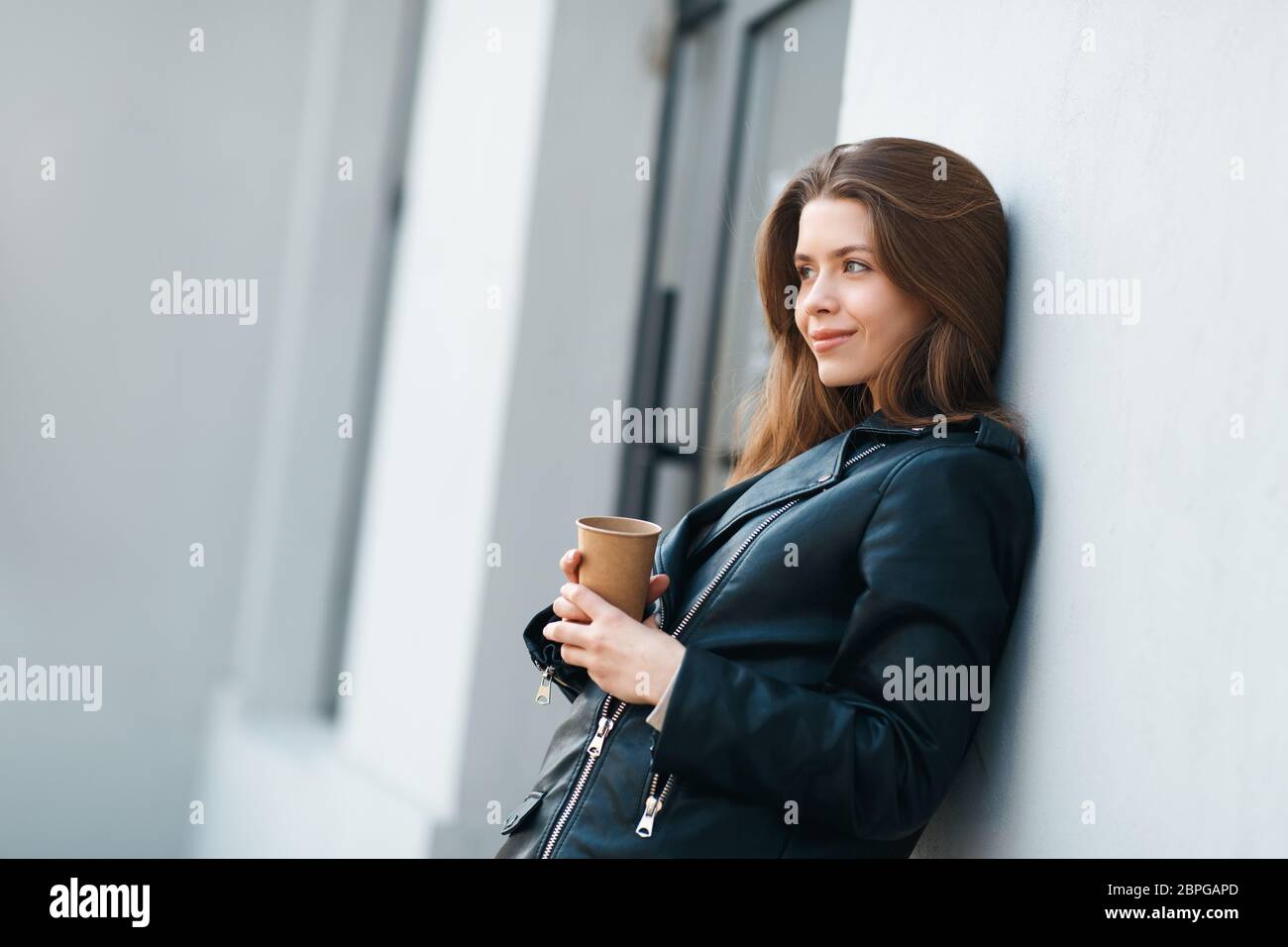 Attractive girl standing near wall hi-res stock photography and images ...