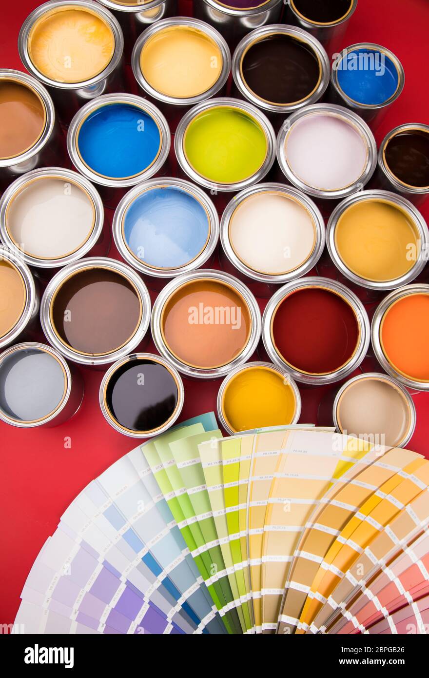 Open buckets with a paint and brush, red background Stock Photo - Alamy