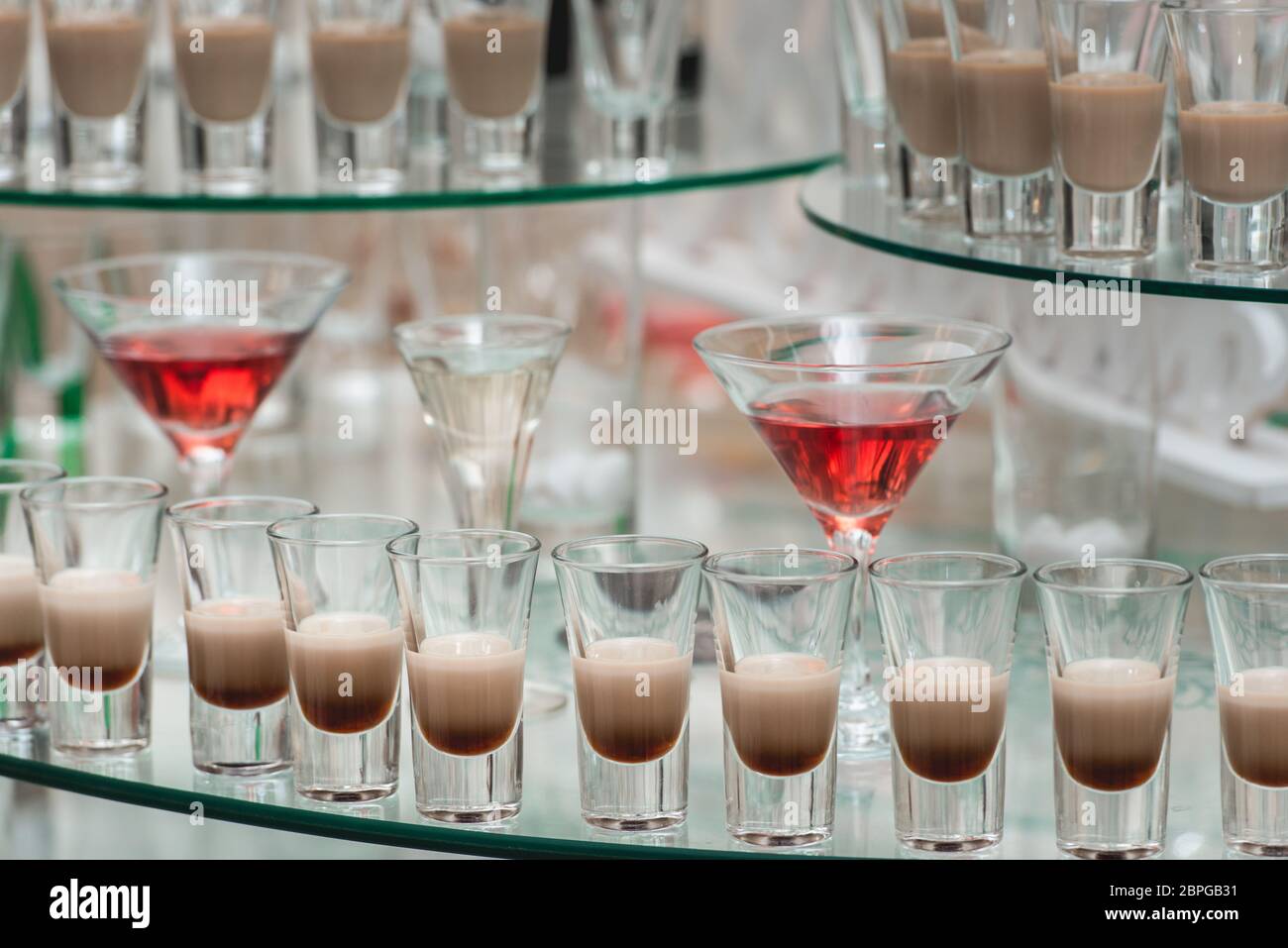 different alcohol drinks on a glass stand. wine, champagne, cognac ...