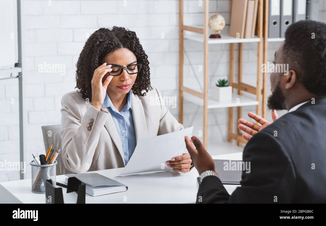 Female human resources manager reading vacancy applicant's resume ...