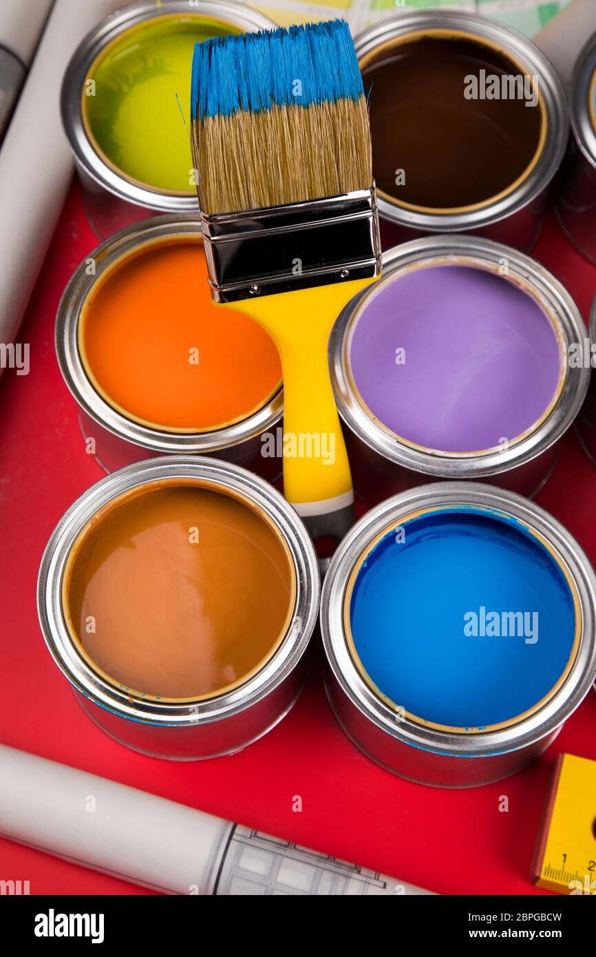 Full Buckets of rainbow colored oil paint on red background Stock Photo ...