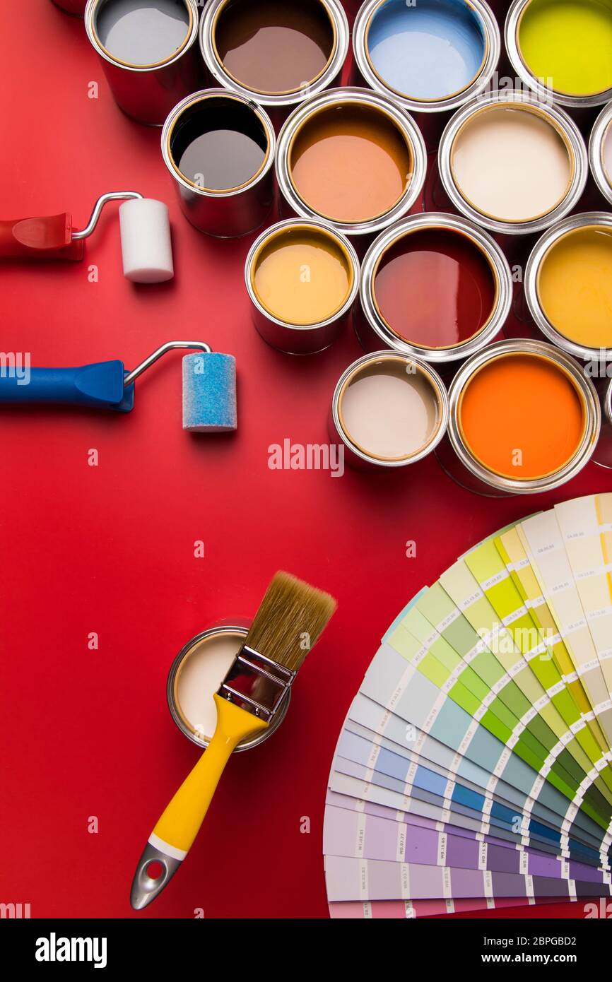 Collection of colored paints cans, Brush, red background Stock Photo ...