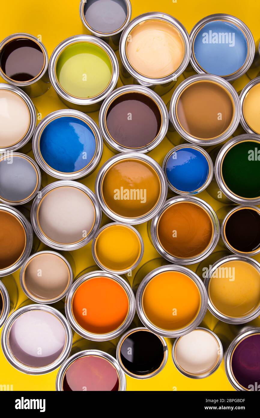 Full Buckets of rainbow colored oil paint on yellow background Stock ...