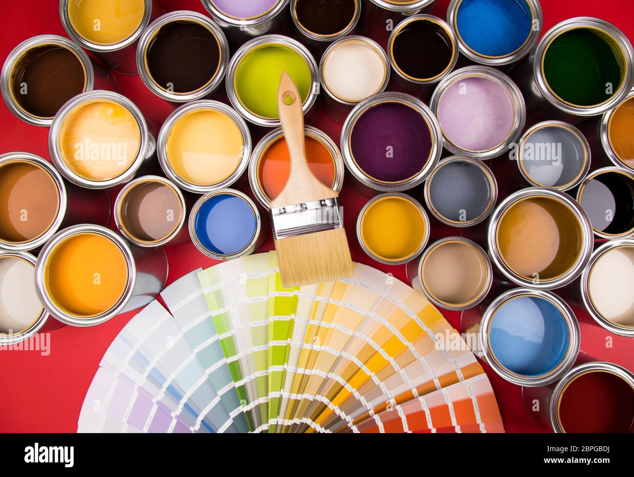 Collection of colored paints cans, Brush, red background Stock Photo ...