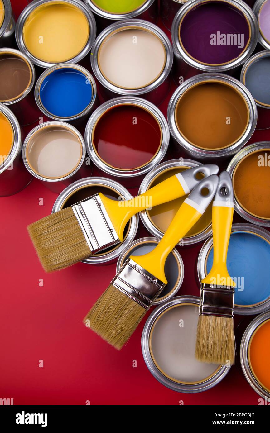 Collection of colored paints cans, Brush, red background Stock Photo ...