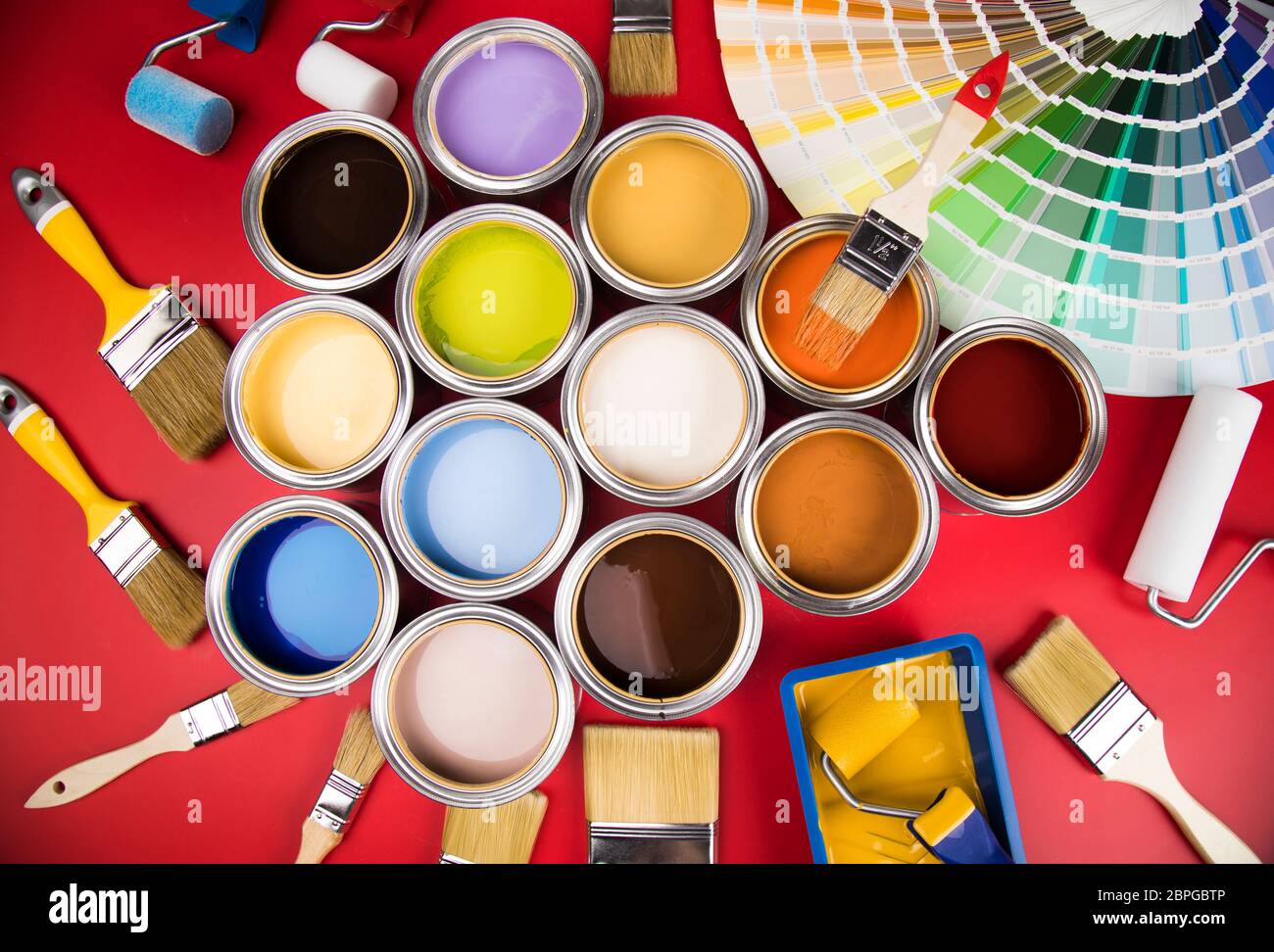Collection of colored paints cans, Brush, red background Stock Photo ...