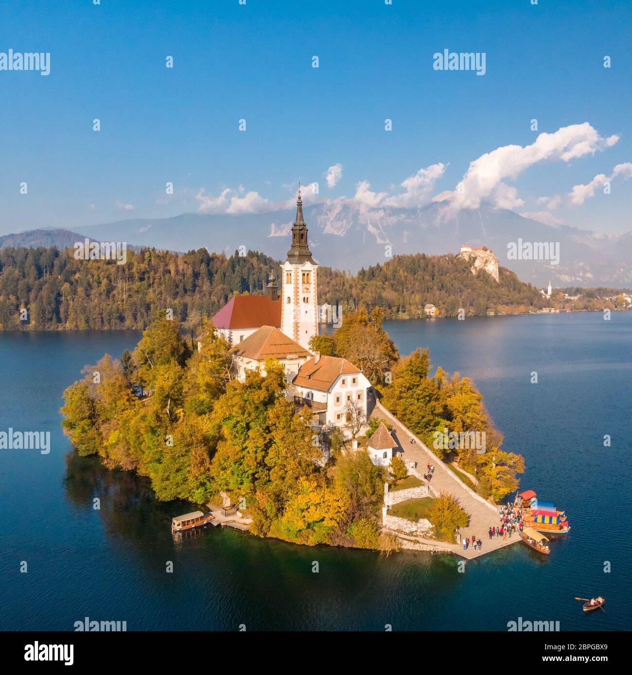 Bled island on lake Bled, and Bled castle and mountains in background ...