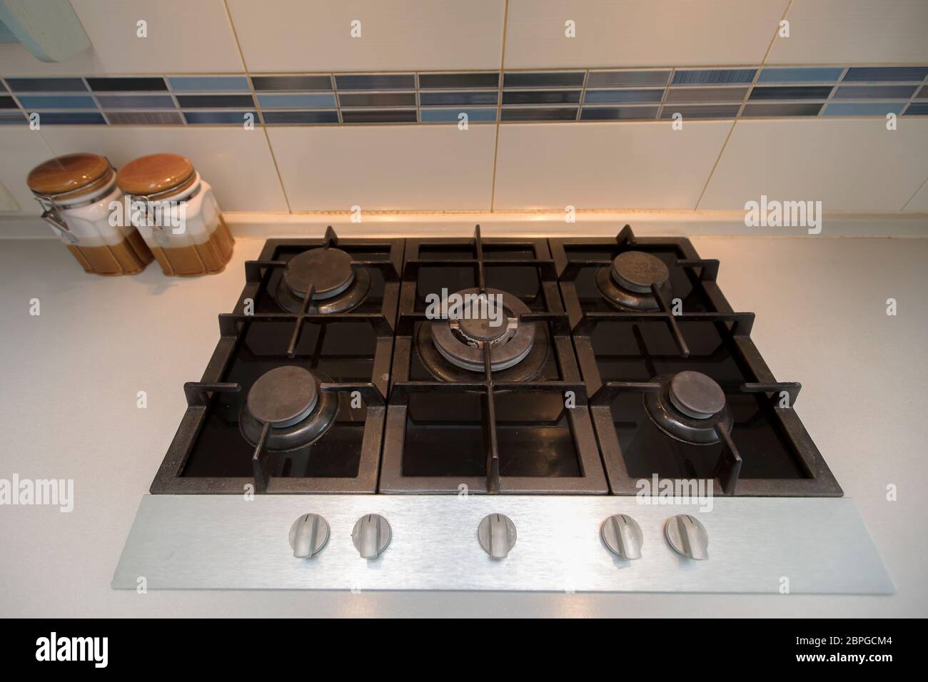 Gas panel built into the kitchen. Six-burner stove Stock Photo - Alamy