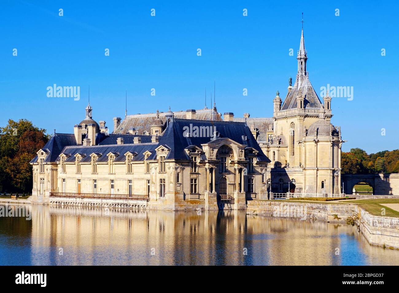 View of Chantilly castle with reflection in water, France Stock Photo ...
