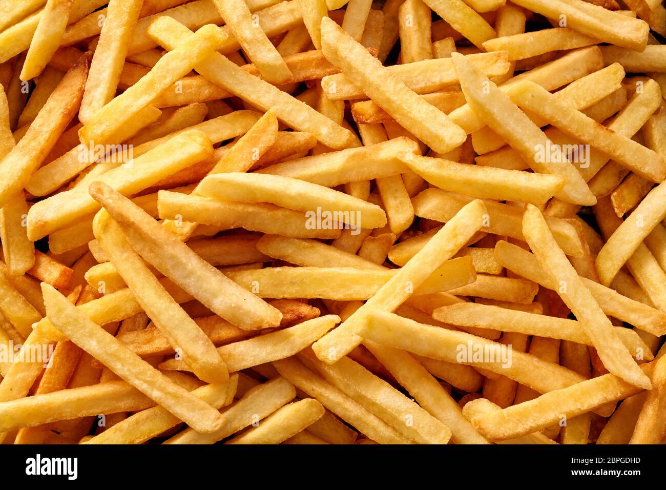Overhead view of golden deep fried French fries food in full frame ...