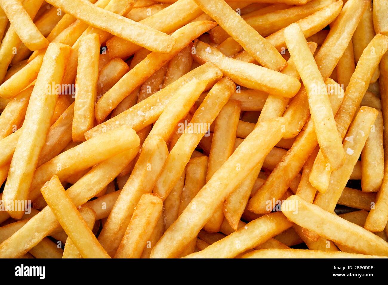 Fresh golden potato french fries in full frame, viewed from above in ...