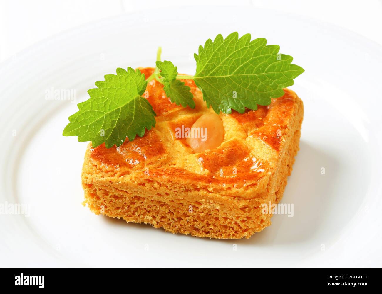 Small square cake filled with thick almond paste Stock Photo - Alamy