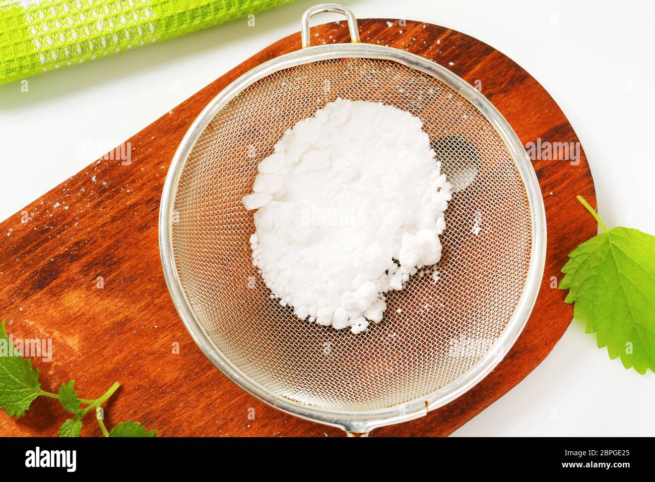 Powdered sugar in a metal sieve Stock Photo - Alamy