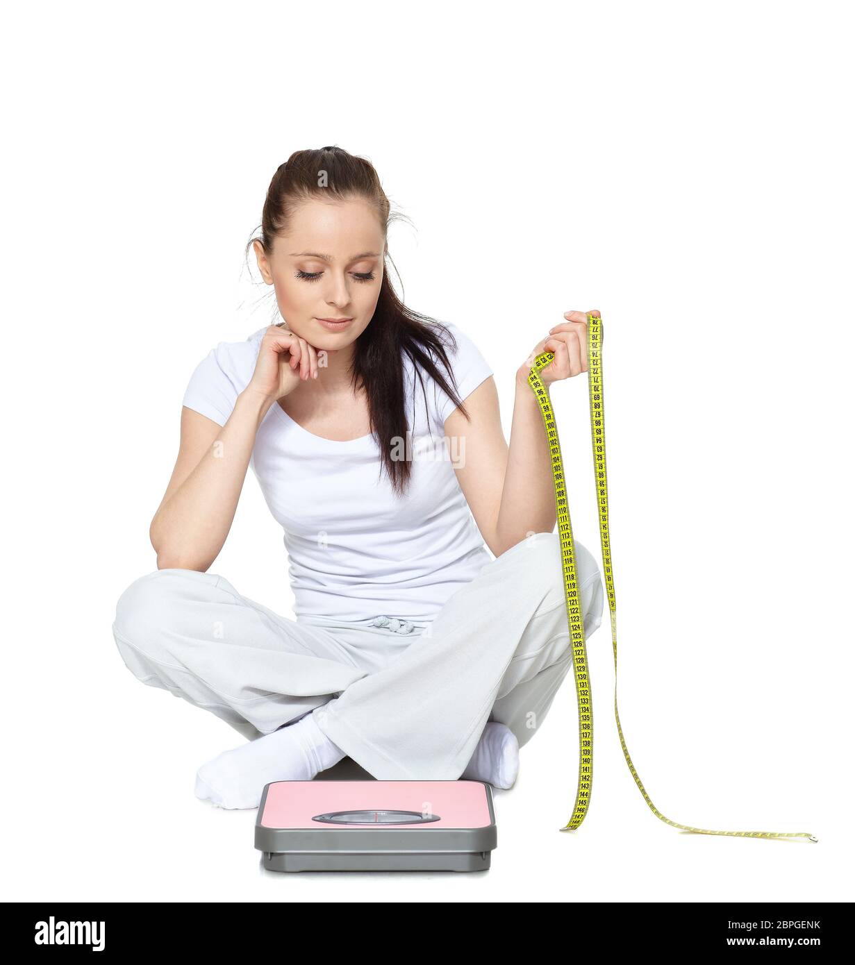 Young beautiful woman with scales on a white background Stock Photo - Alamy