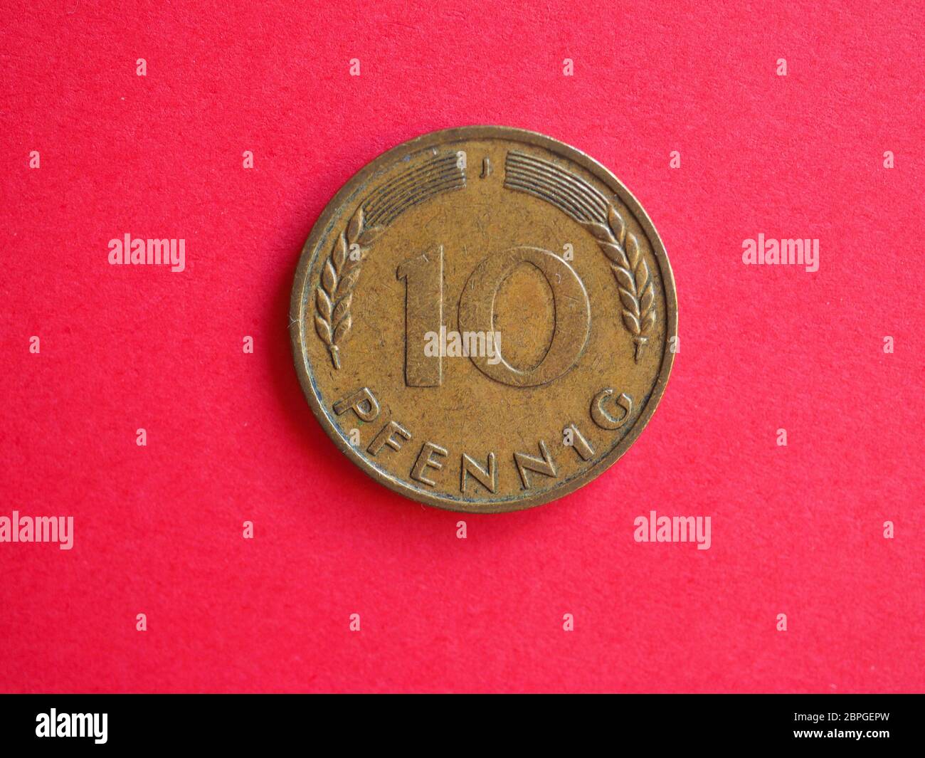 Vintage 10 pfenning coin from Germany over red background Stock Photo ...