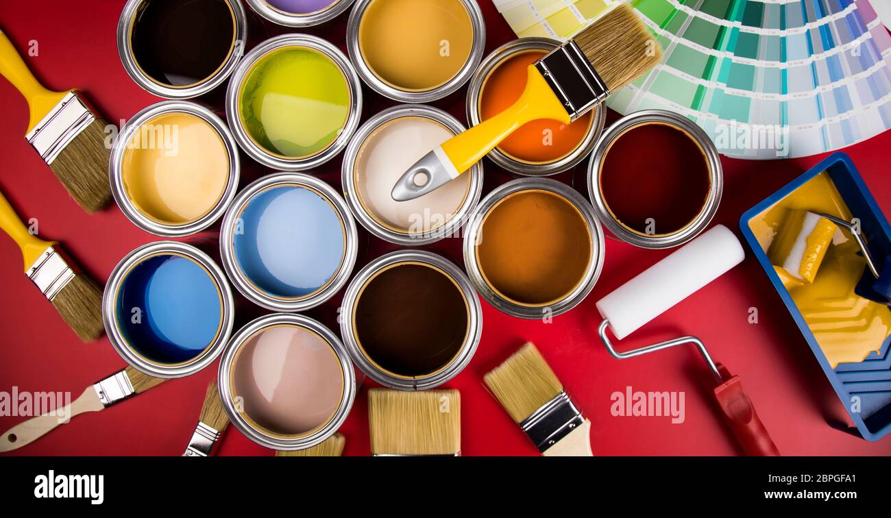 Open buckets with a paint and brush, red background Stock Photo - Alamy