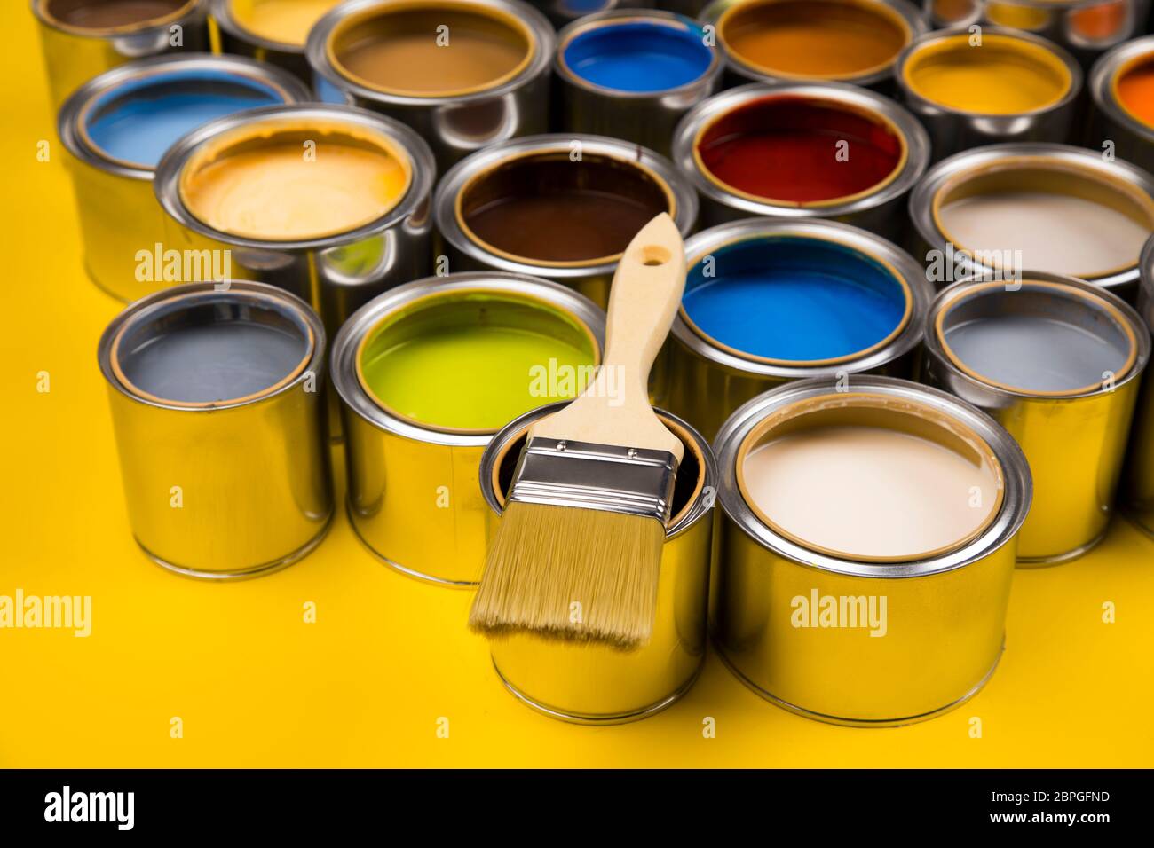 Metal tin cans with color paint and paintbrush Stock Photo - Alamy