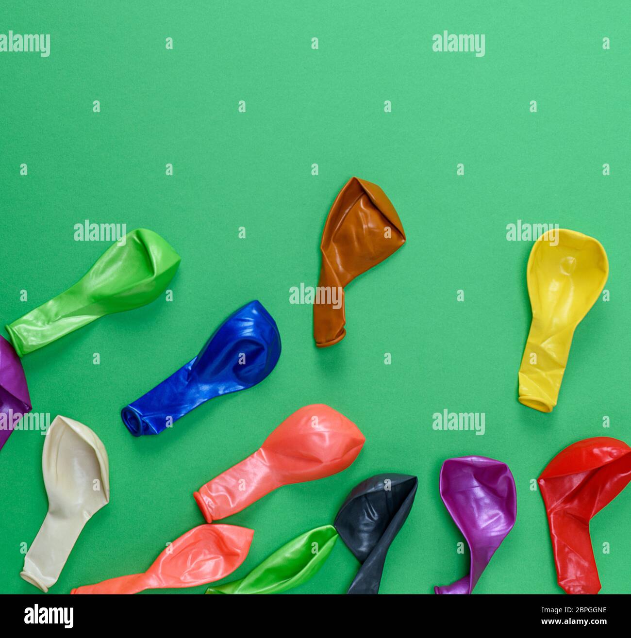 colorful deflated balloons on a green background, copy space Stock ...