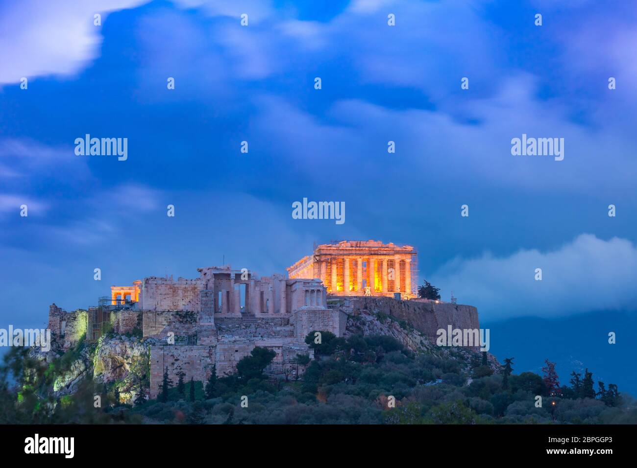 Aerial view of the Acropolis Hill, crowned with Parthenon during evening blue hour in Athens ...
