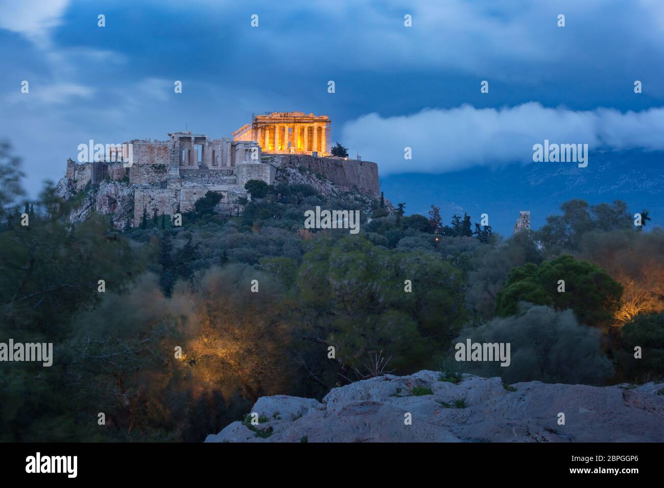 Aerial view of the Acropolis Hill, crowned with Parthenon during evening blue hour in Athens ...