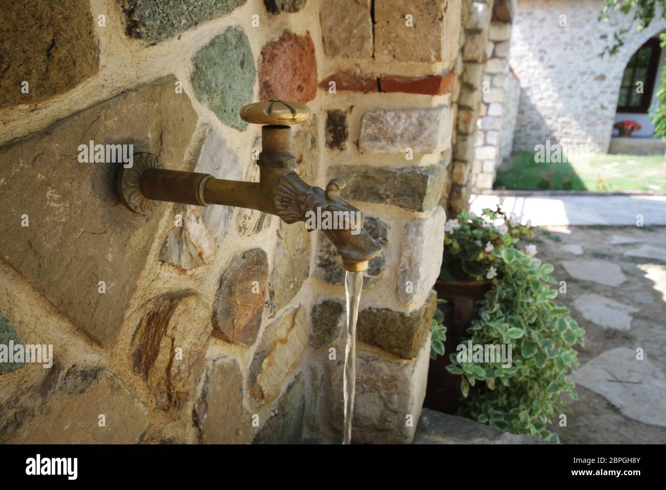 bronze water faucet with a lions head old tap Stock Photo - Alamy