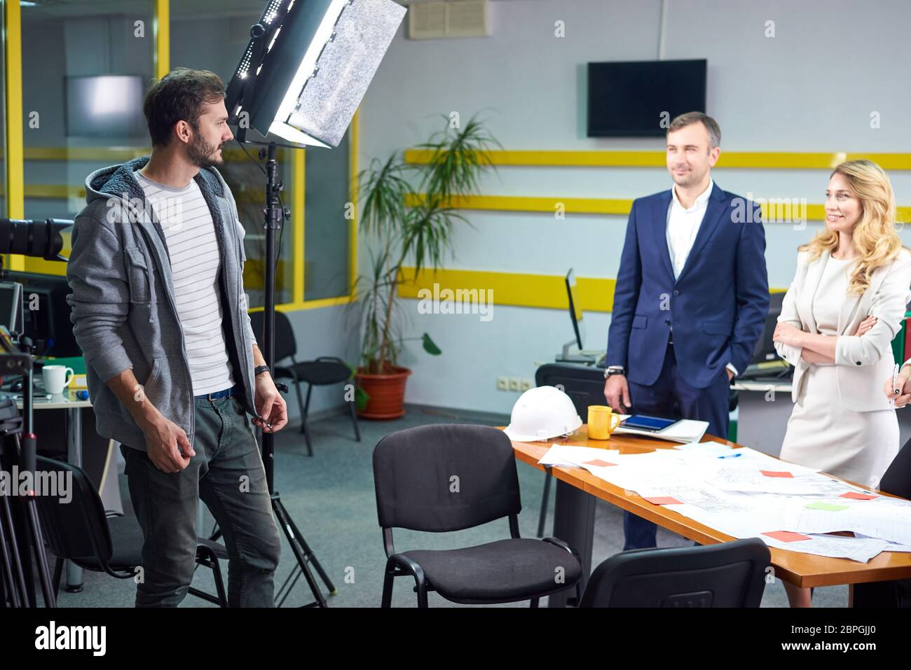 Film director discussing movie plan with the actors in the office scene ...