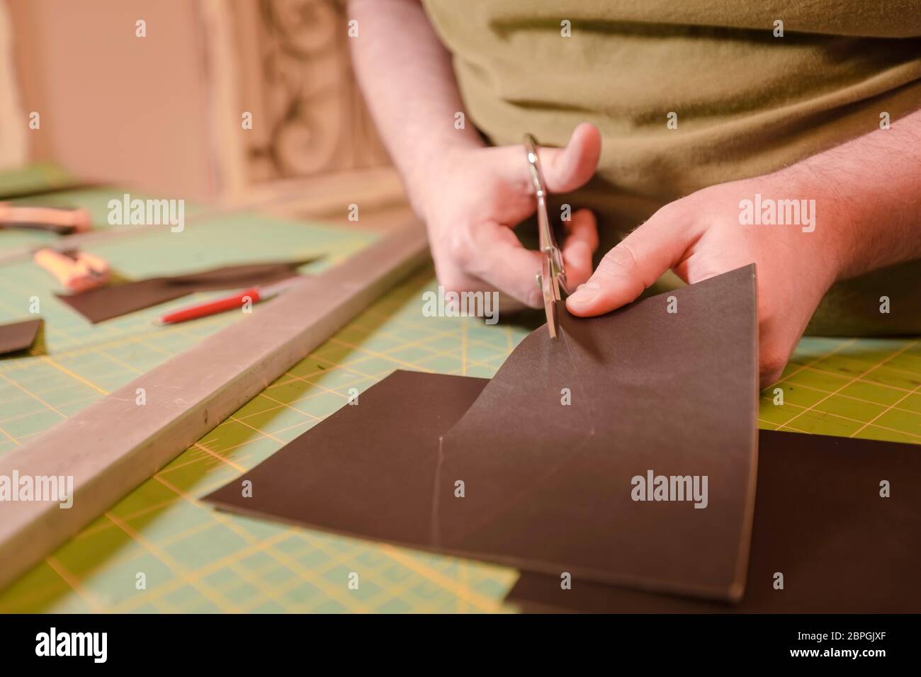 Cutting leather pieces with specialized scissors Stock Photo - Alamy