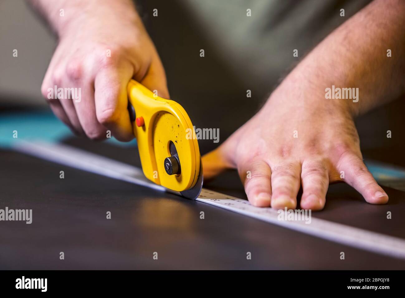 Cutting leather with a rotary cutter Stock Photo - Alamy