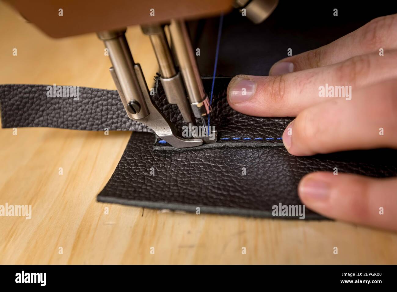 Closeup adding aleather pocket using an industrial sewing machine Stock ...