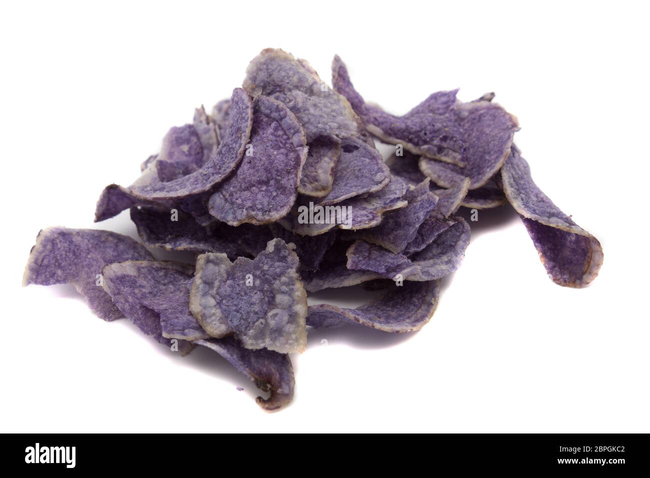 Blue potatoes chips on a white background Stock Photo - Alamy