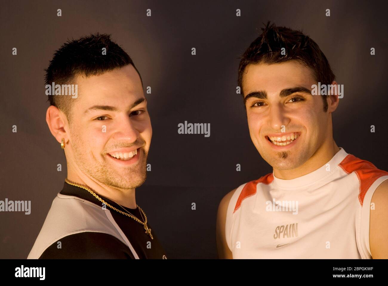 Two young men smiling and looking at the camera Stock Photo - Alamy
