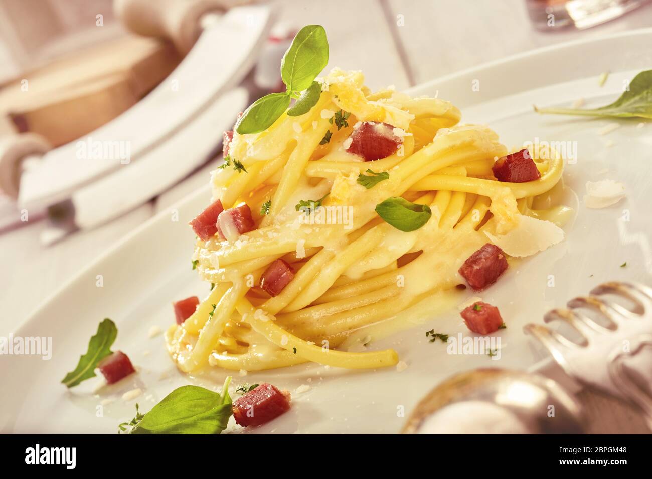 Gourmet presentation of spaghetti with diced fried bacon and parmesan ...