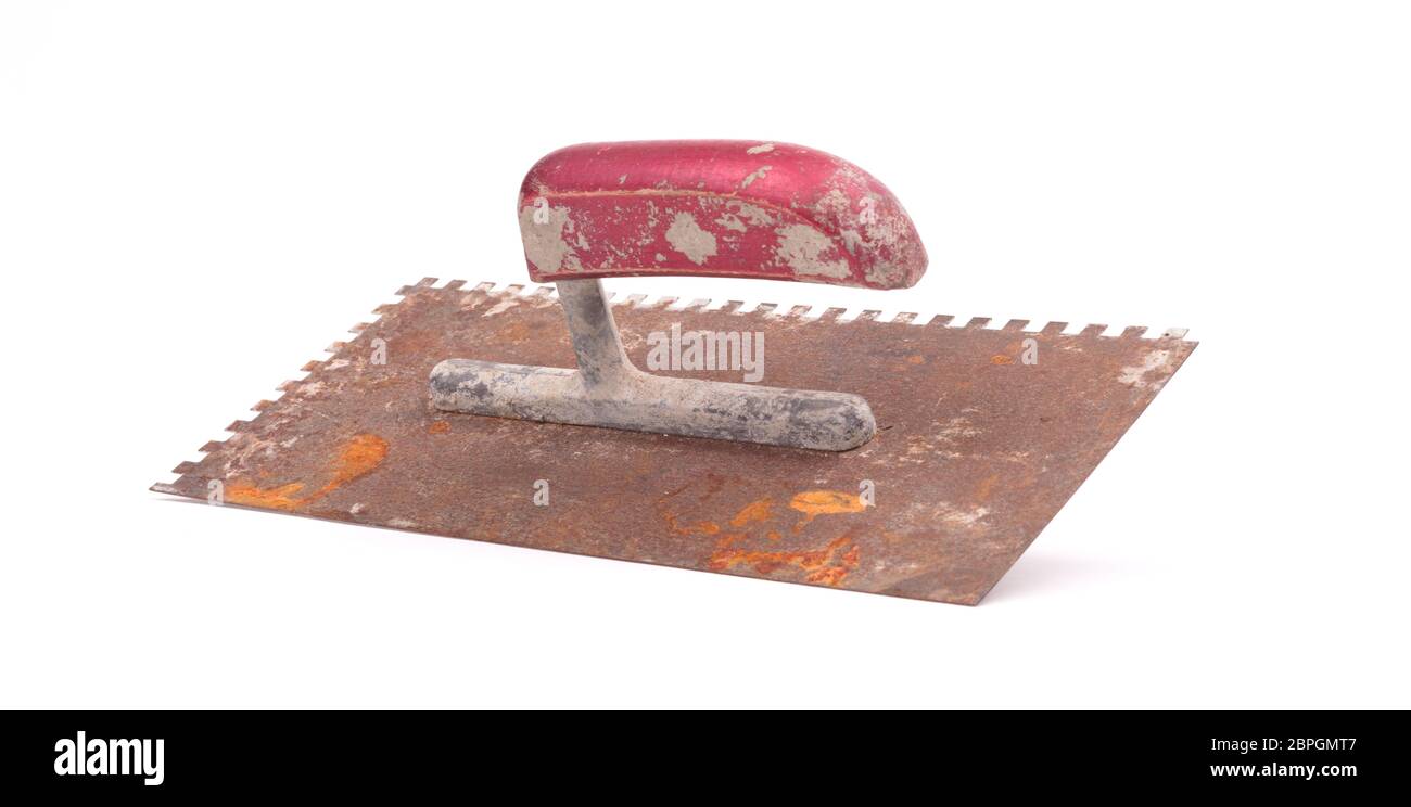 Rusty old notched trowel isolated on white Stock Photo - Alamy