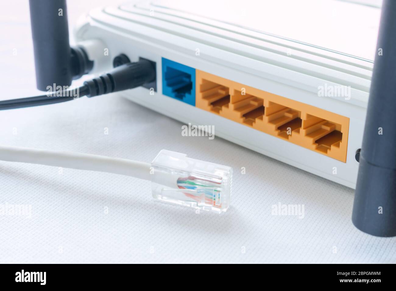internet cable and a router on a white background Stock Photo - Alamy