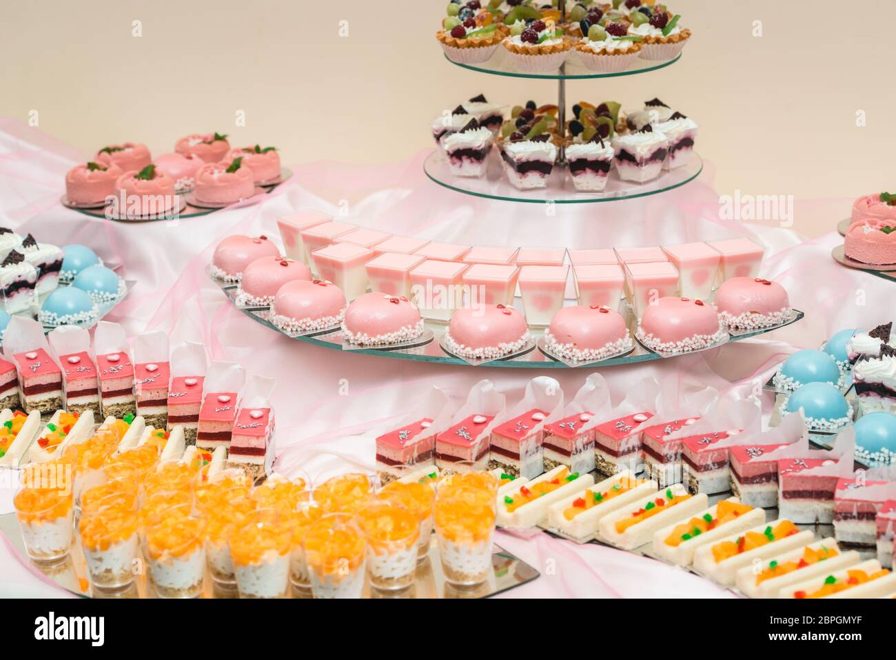 Set of different cakes sweets and desserts arranged on one plate. Party ...