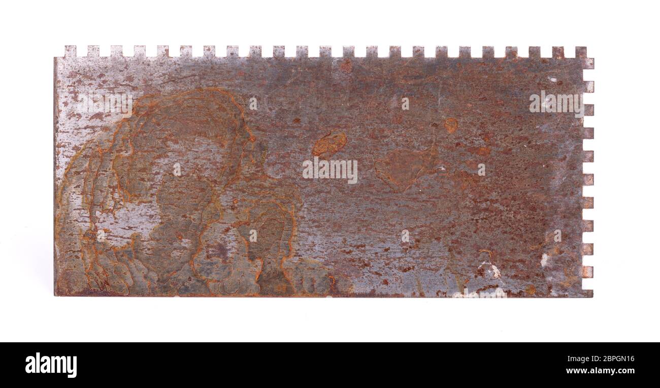 Rusty old notched trowel isolated on white Stock Photo - Alamy