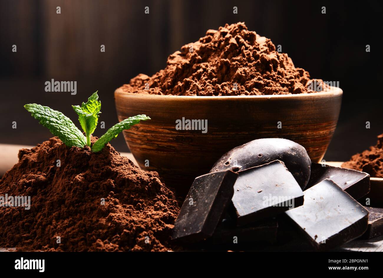 Composition with bowl of cocoa powder on wooden table Stock Photo - Alamy