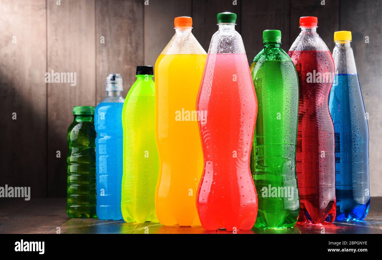 Plastic bottles of assorted carbonated soft drinks in variety of colors ...