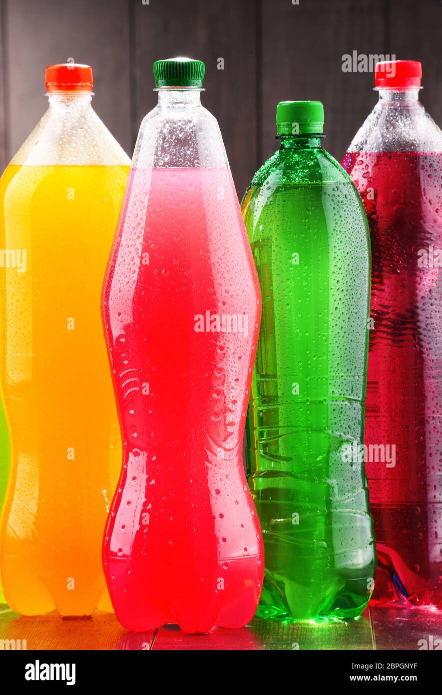 Plastic bottles of assorted carbonated soft drinks in variety of colors ...