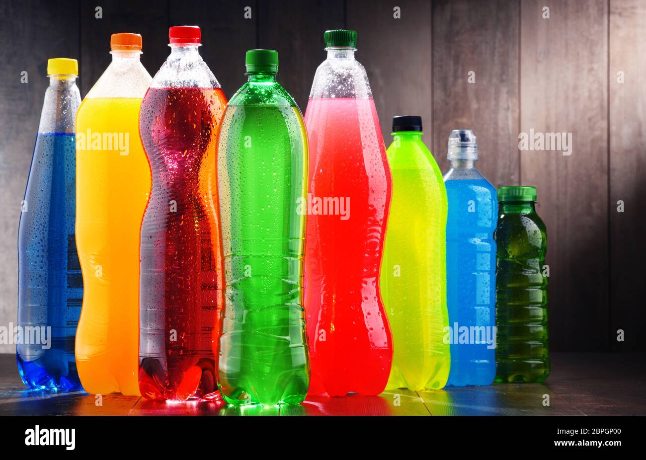 Plastic bottles of assorted carbonated soft drinks in variety of colors ...