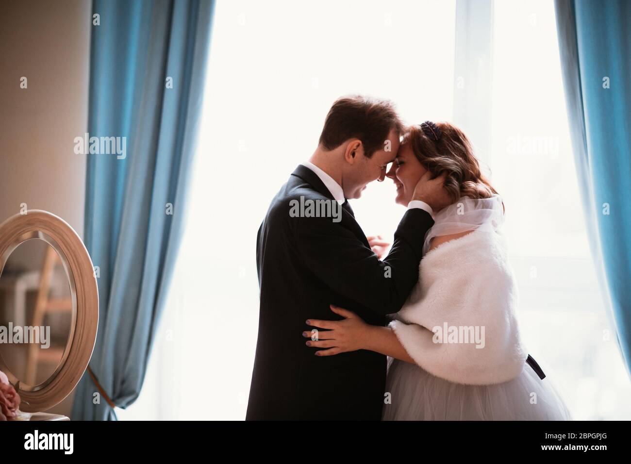 young bride and groom couple in a bright studio photo Stock Photo - Alamy