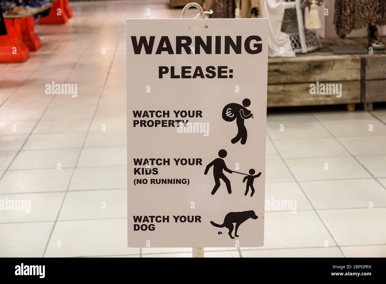 Hazard warning attention sign inside at store Stock Photo - Alamy