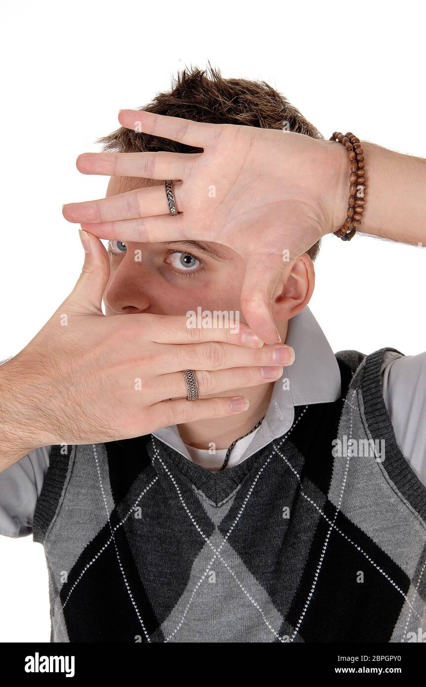 A young man holding his hands ab to take a look how the picture will ...