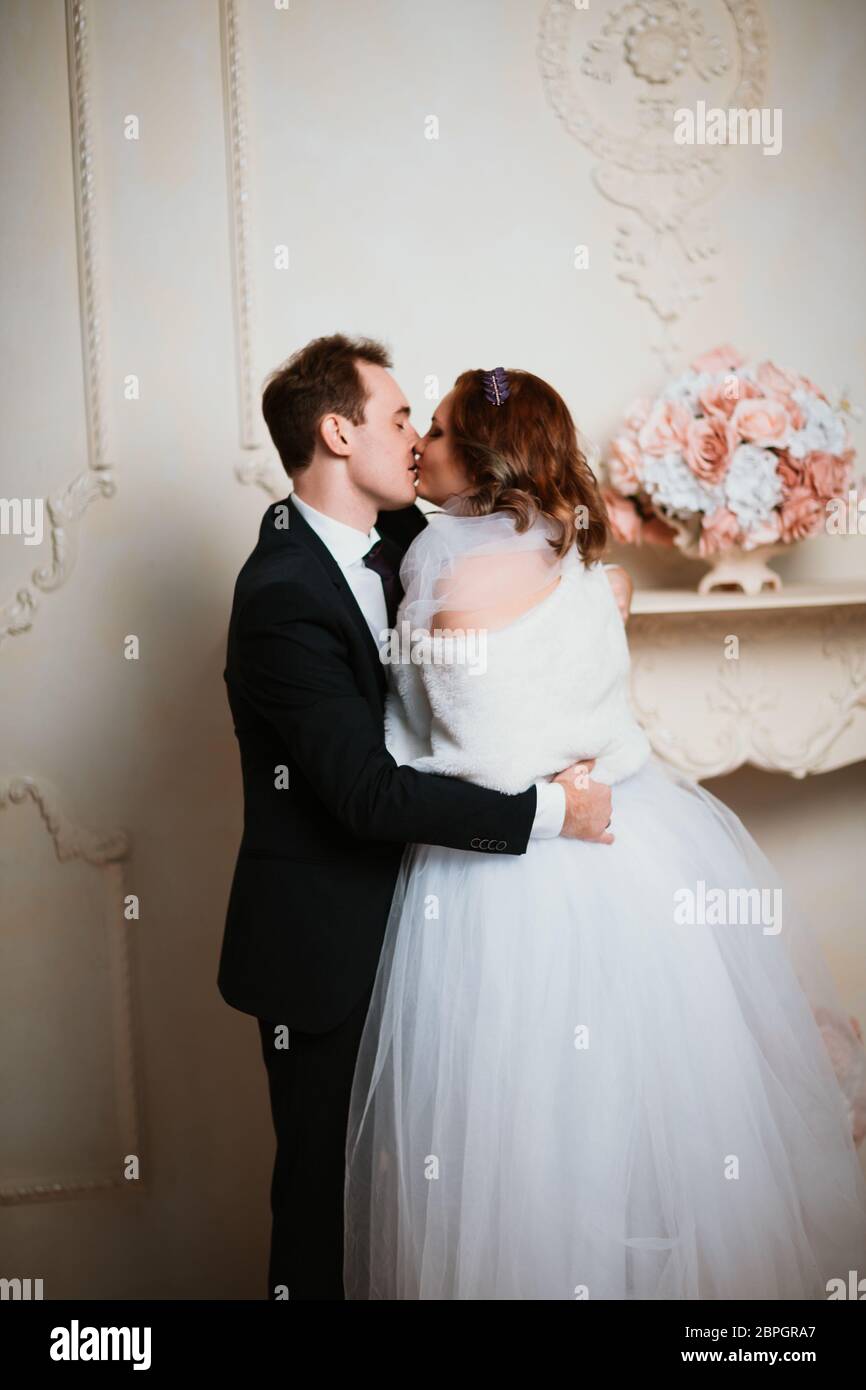 young bride and groom couple in a bright studio photo Stock Photo - Alamy