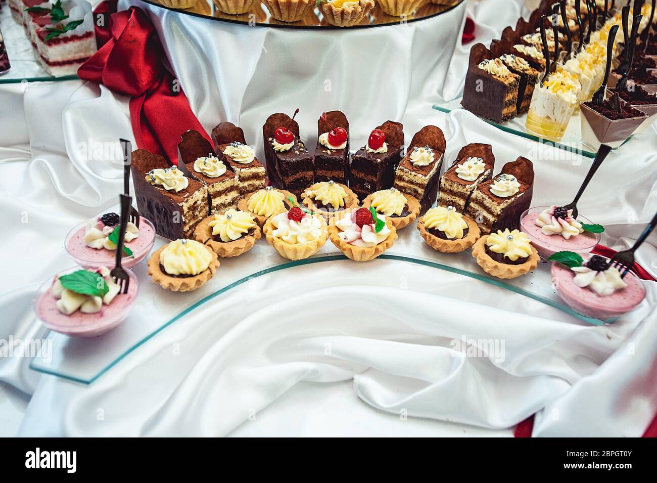 rows of different cakes on a glass stand Stock Photo - Alamy