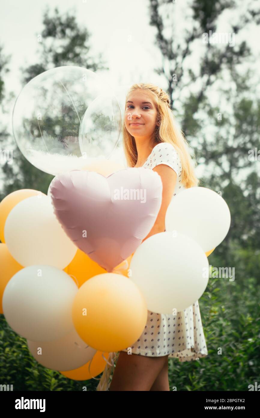 young girl with balloons on nature background Stock Photo - Alamy