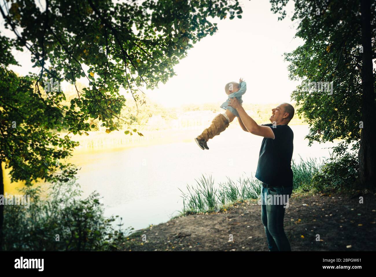 happy dad and baby on nature background Stock Photo - Alamy