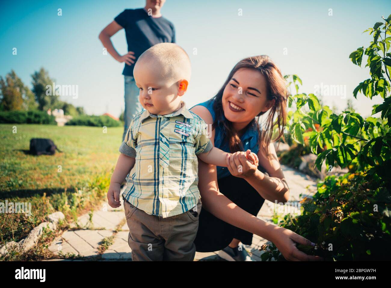 Happy family with baby son on nature background Stock Photo - Alamy