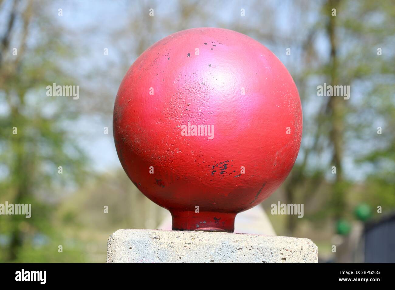 Red stone ball on a bridge railing, Germany, Europe Stock Photo - Alamy