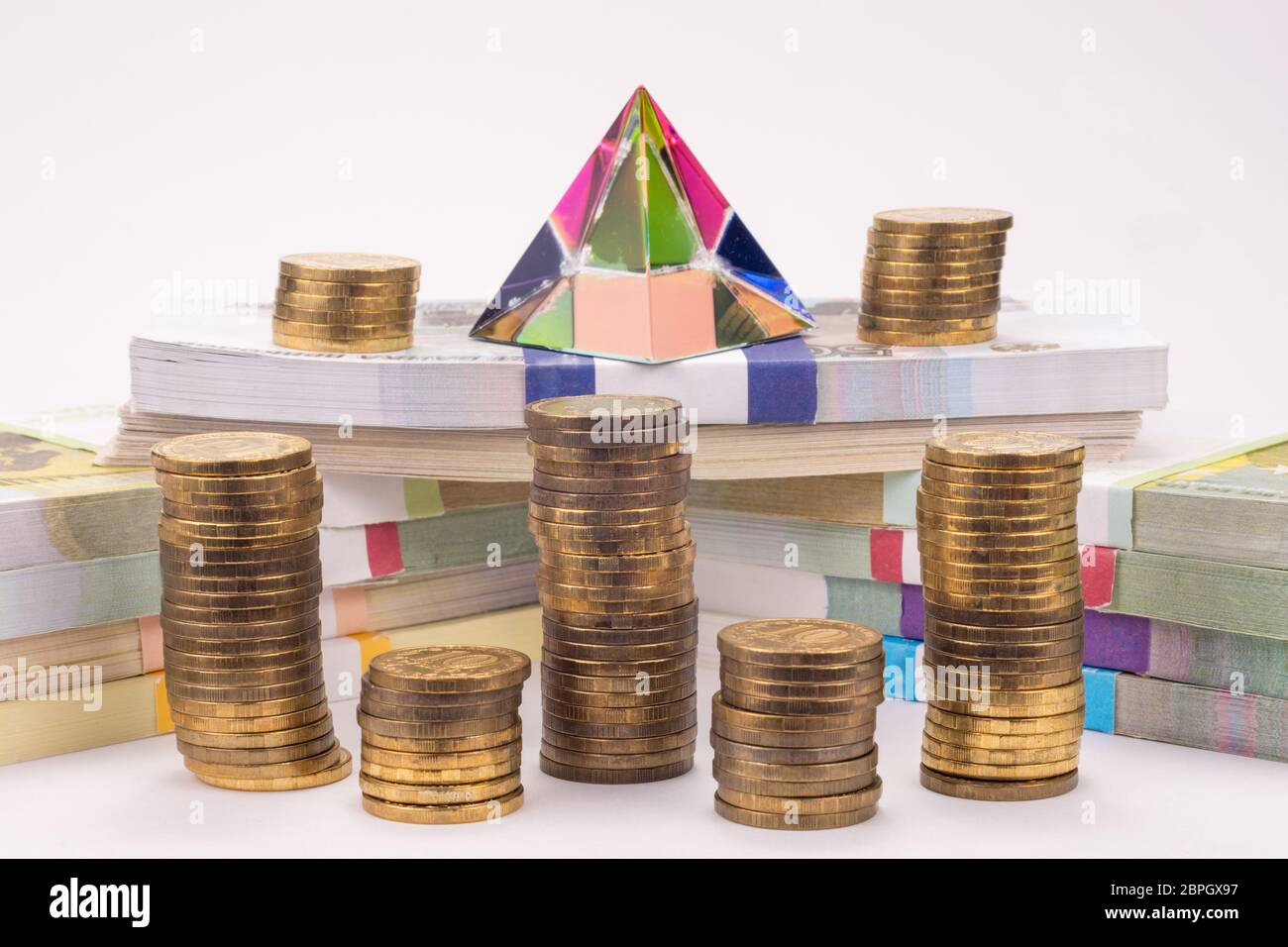 Financial pyramid, wads of money and stacks of coins Stock Photo - Alamy